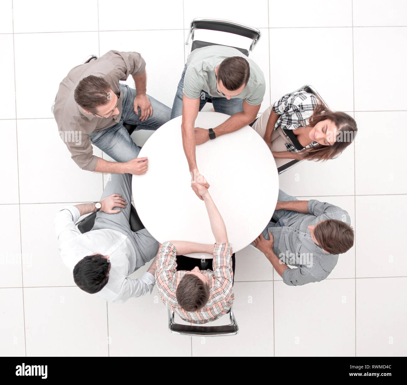 top view. handshake colleagues at the round table Stock Photo - Alamy