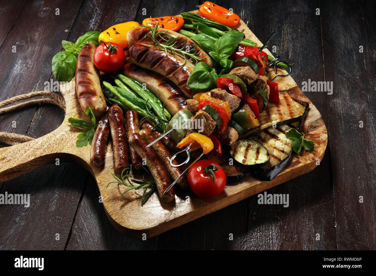 Assorted delicious grilled meat with vegetable on a barbecue and grilled pork shish or kebab on ...