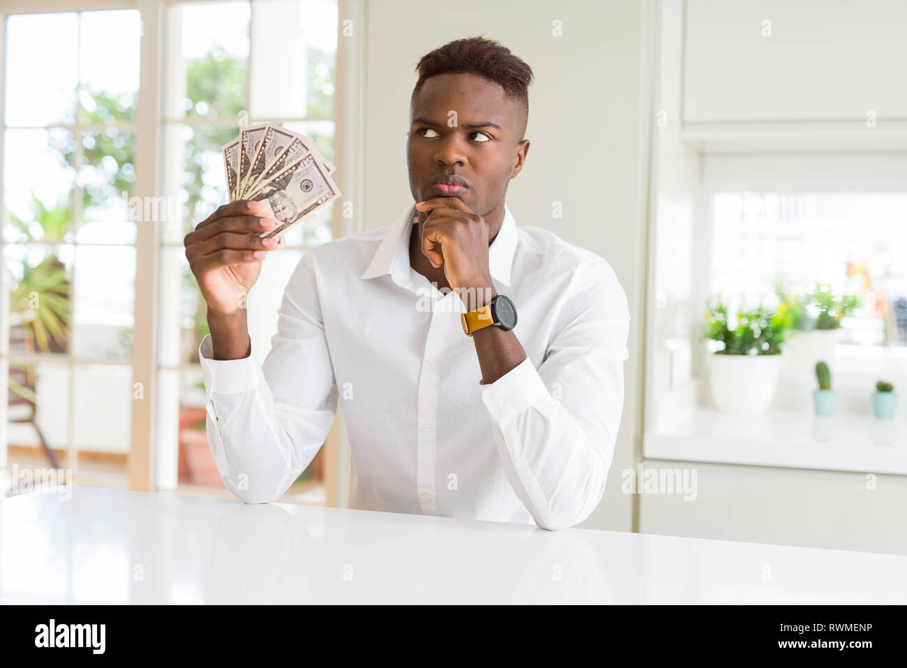 African american man holding fifty dollars bank notes serious face ...