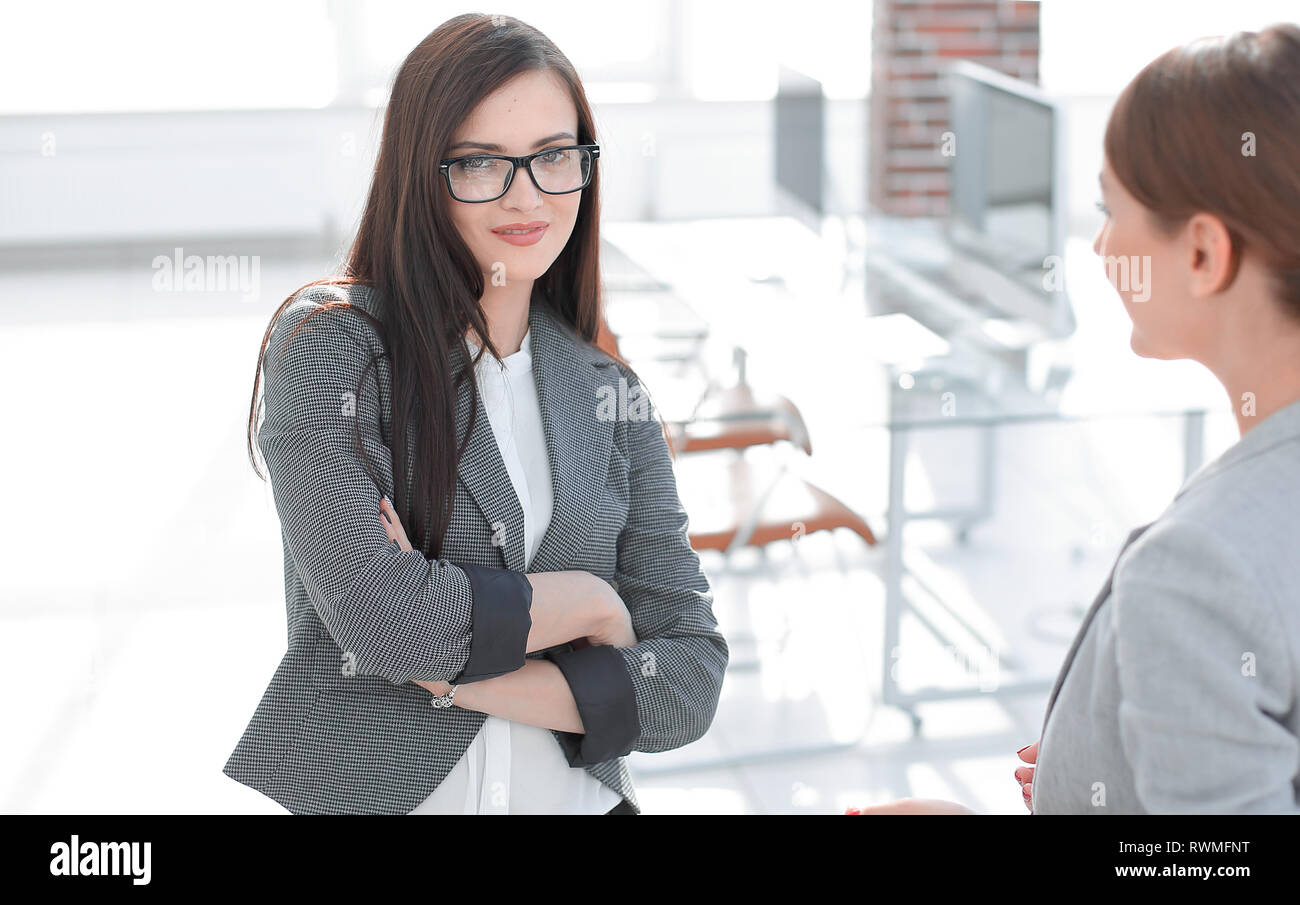 two employees talking standing in the office Stock Photo - Alamy