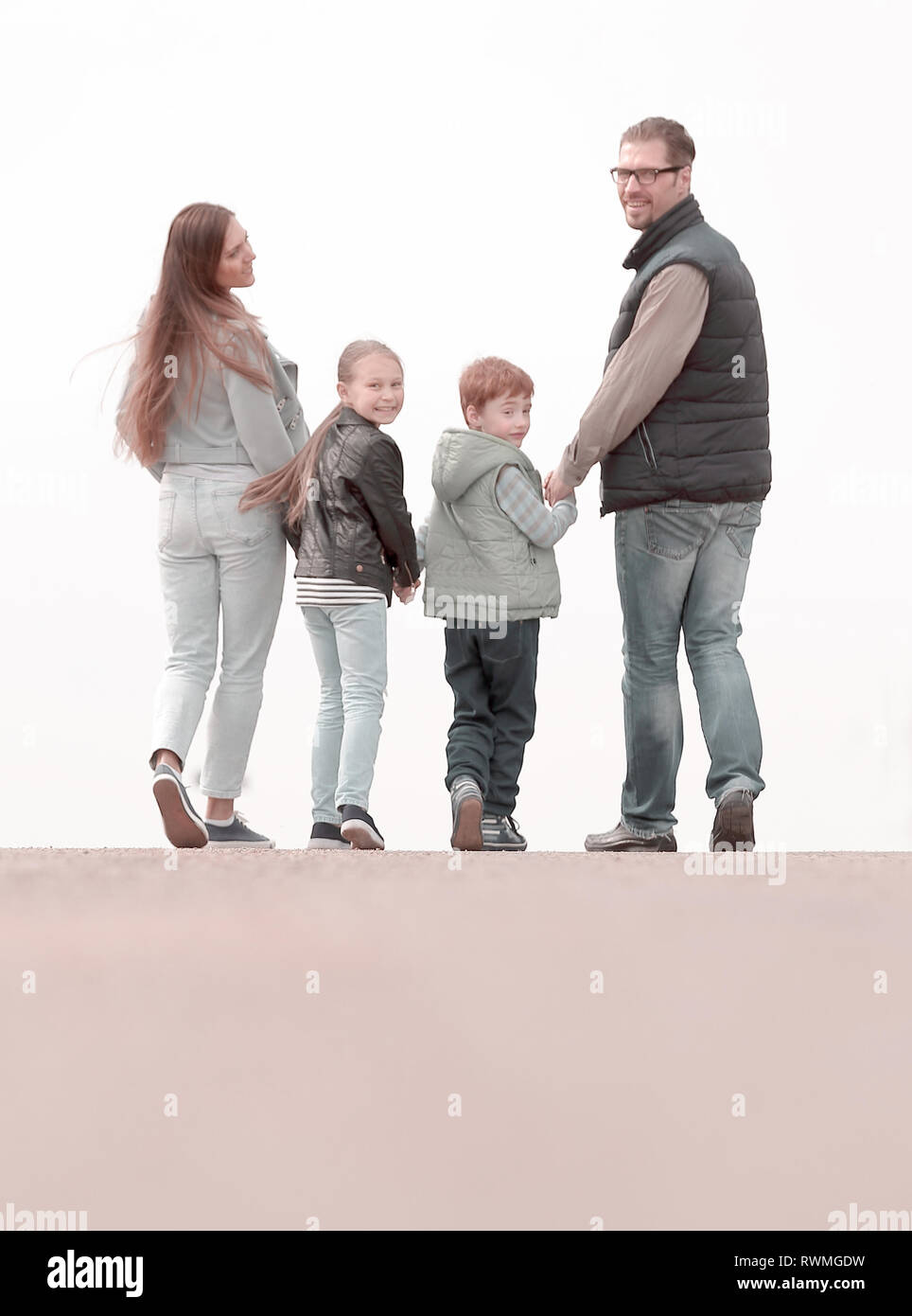 rear view.happy family walking the road together Stock Photo - Alamy