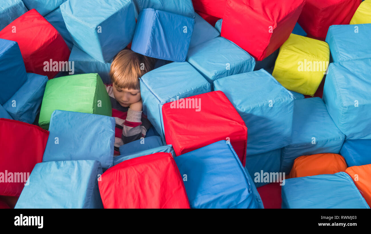Portrait of boy playing with soft cubes. Boy sleeping at Entertainment ...