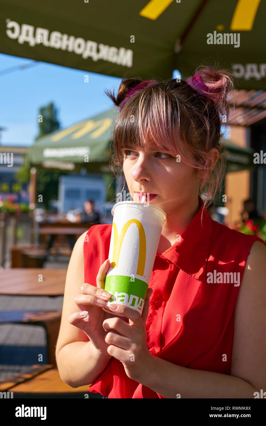 KALININGRAD, RUSSIA - CIRCA SEPTEMBER, 2018: young woman drinks Coca ...