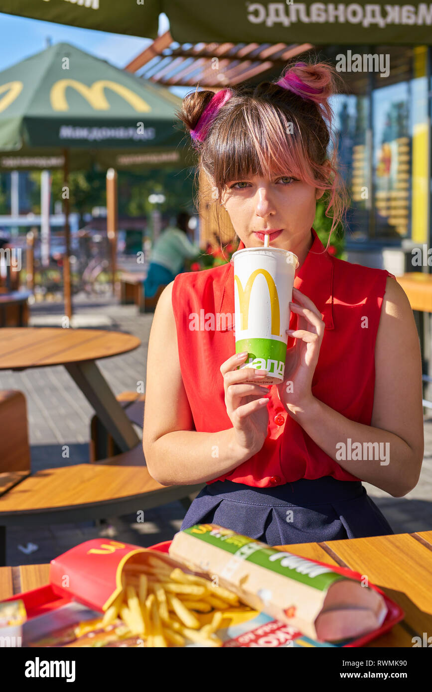KALININGRAD, RUSSIA - CIRCA SEPTEMBER, 2018: young woman drinks Coca ...