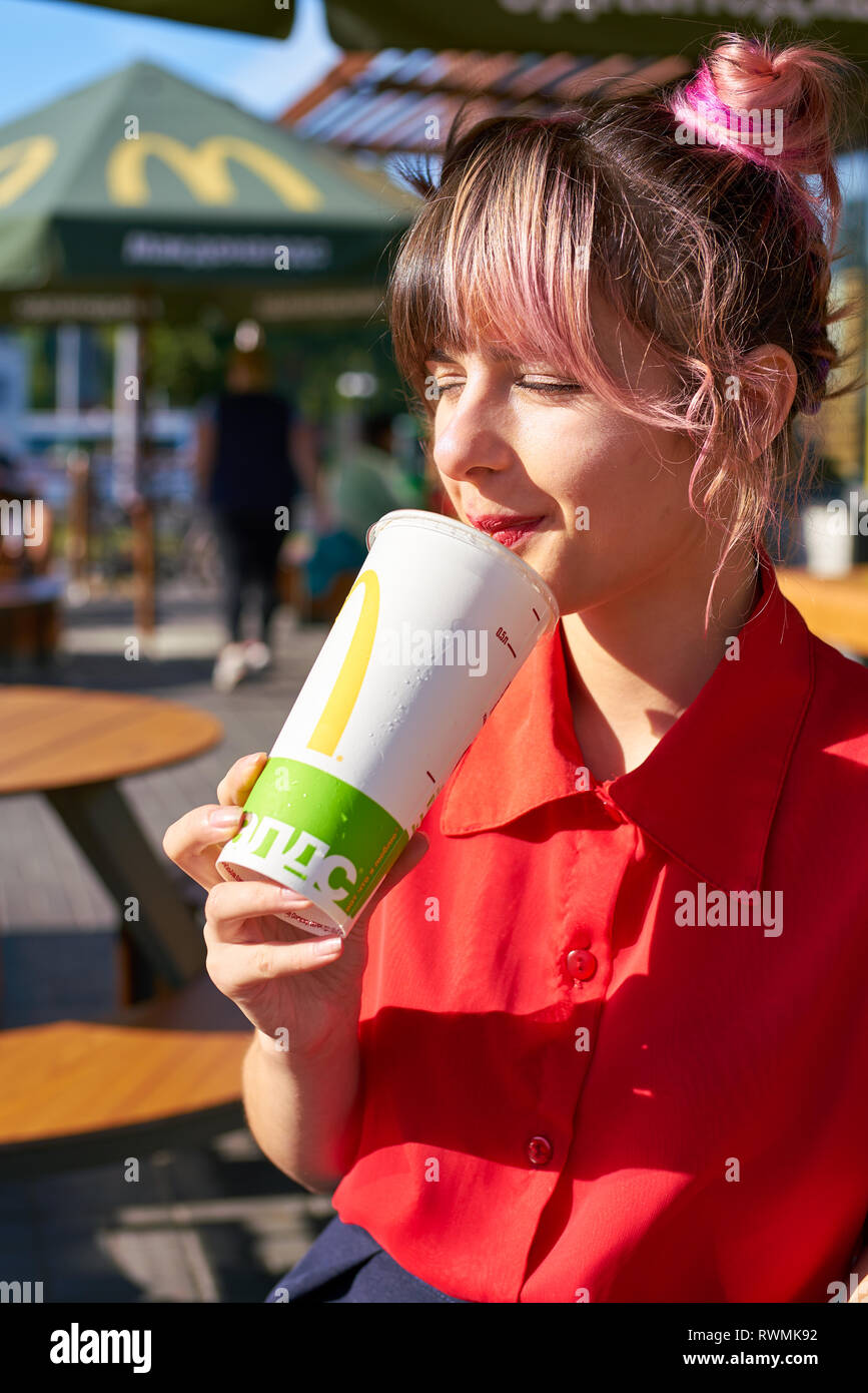 KALININGRAD, RUSSIA - CIRCA SEPTEMBER, 2018: young woman drinks Coca ...