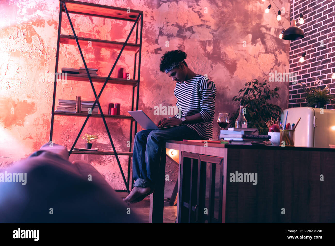 African American guy sitting in the kitchen and trying to diversify the ...