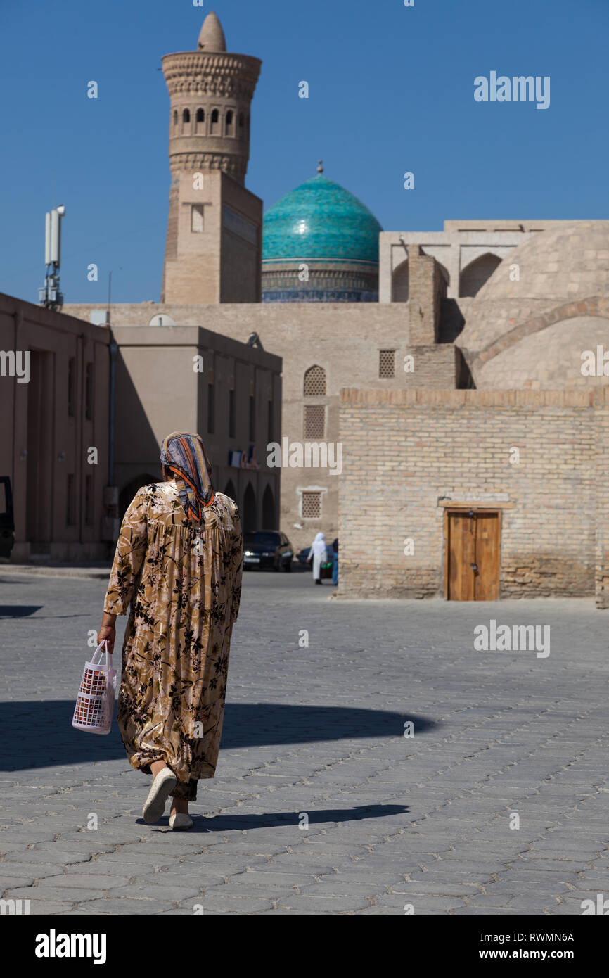 Uzbek woman walking in Bukhara, Uzbekistan Stock Photo - Alamy