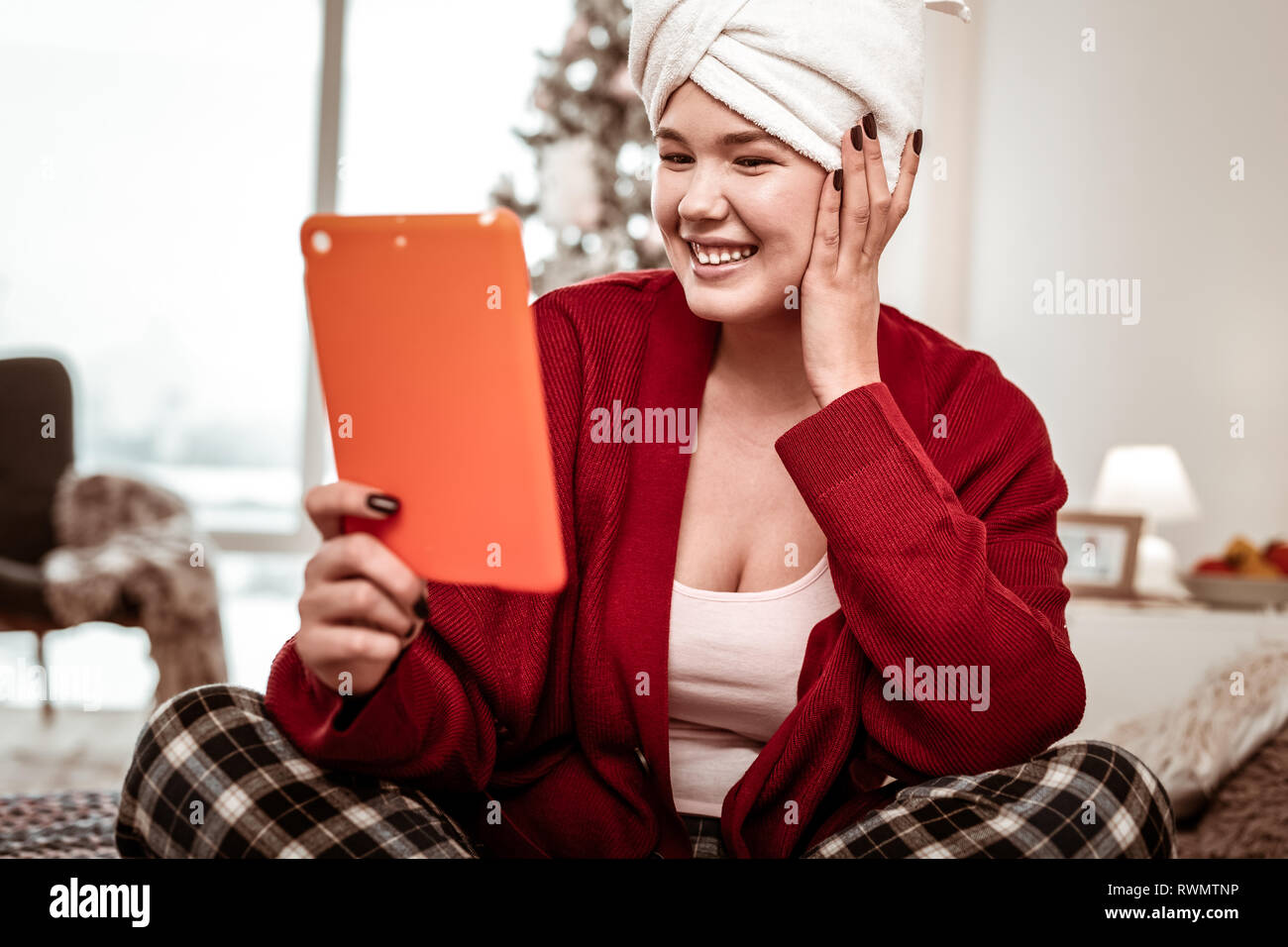 Smiling beaming woman being contented with information on tablet Stock ...