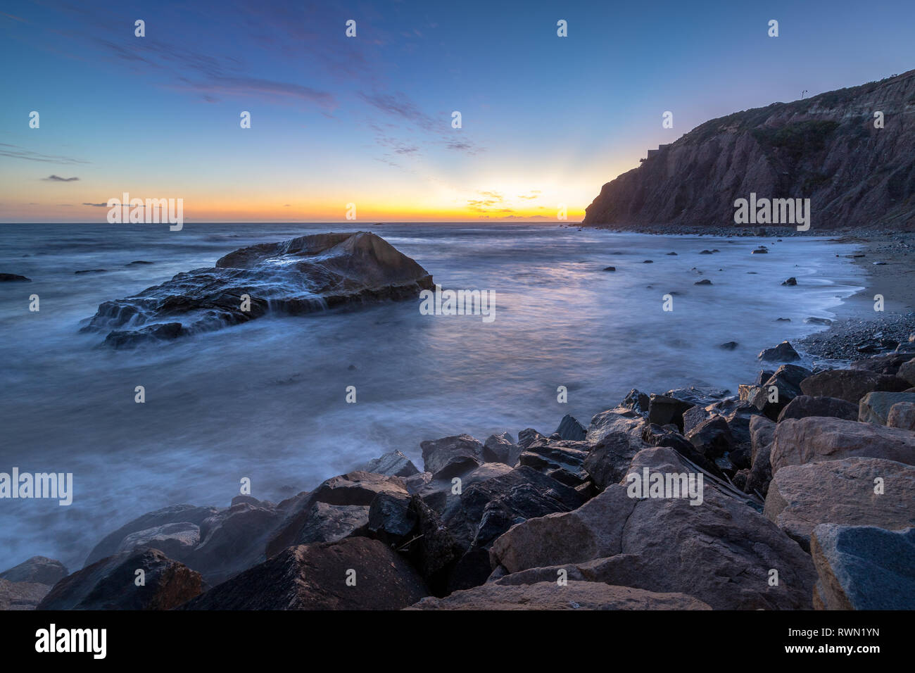Long exposure photo of striking tall cliffs and waves crashing into a ...