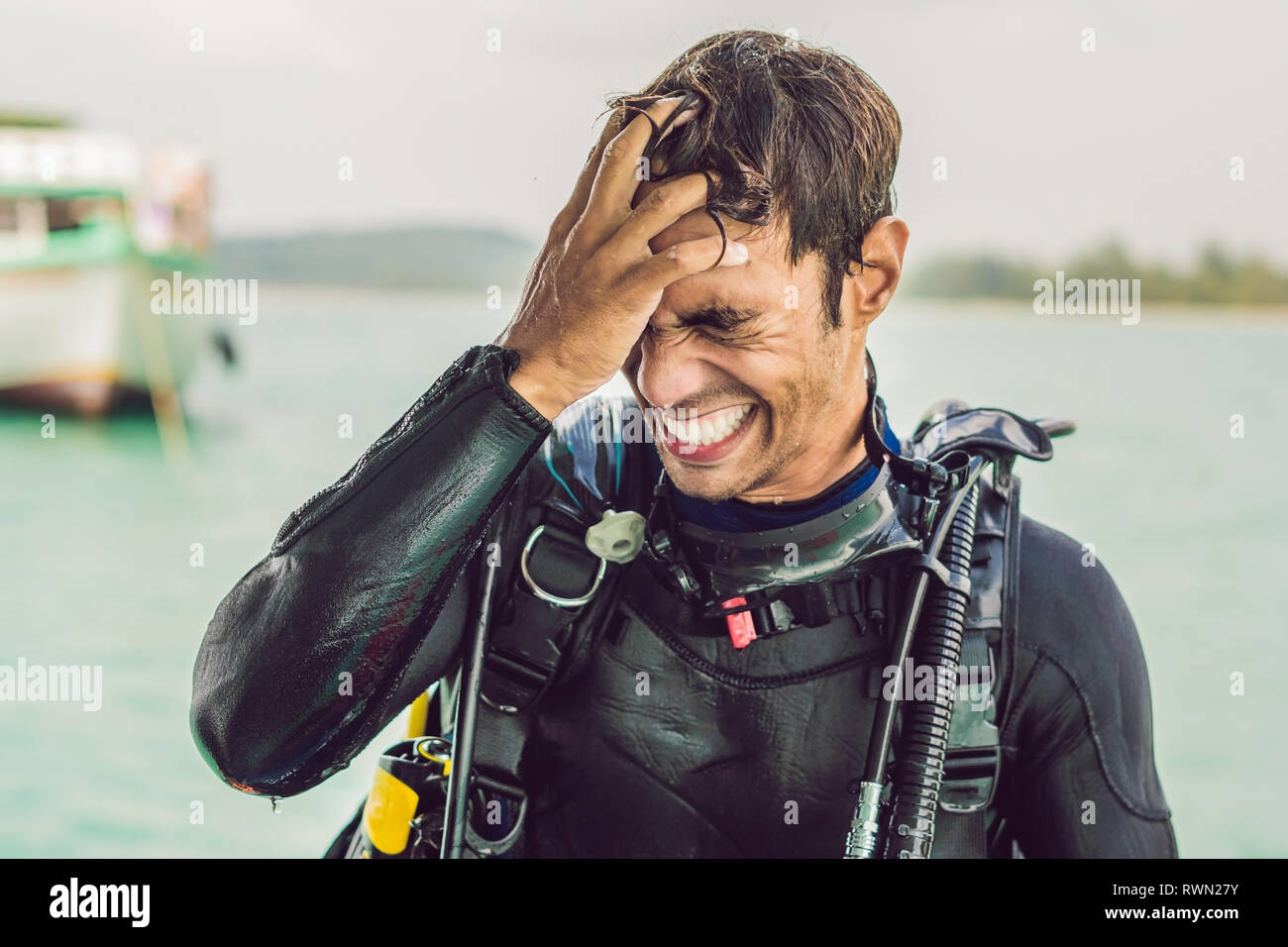 Happy diver returns to the ship after diving Stock Photo - Alamy