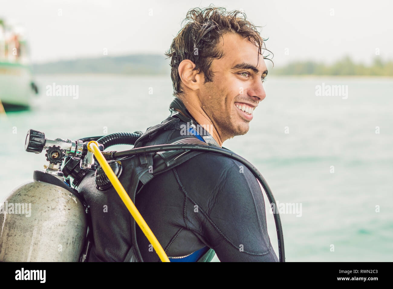 Happy diver returns to the ship after diving Stock Photo - Alamy