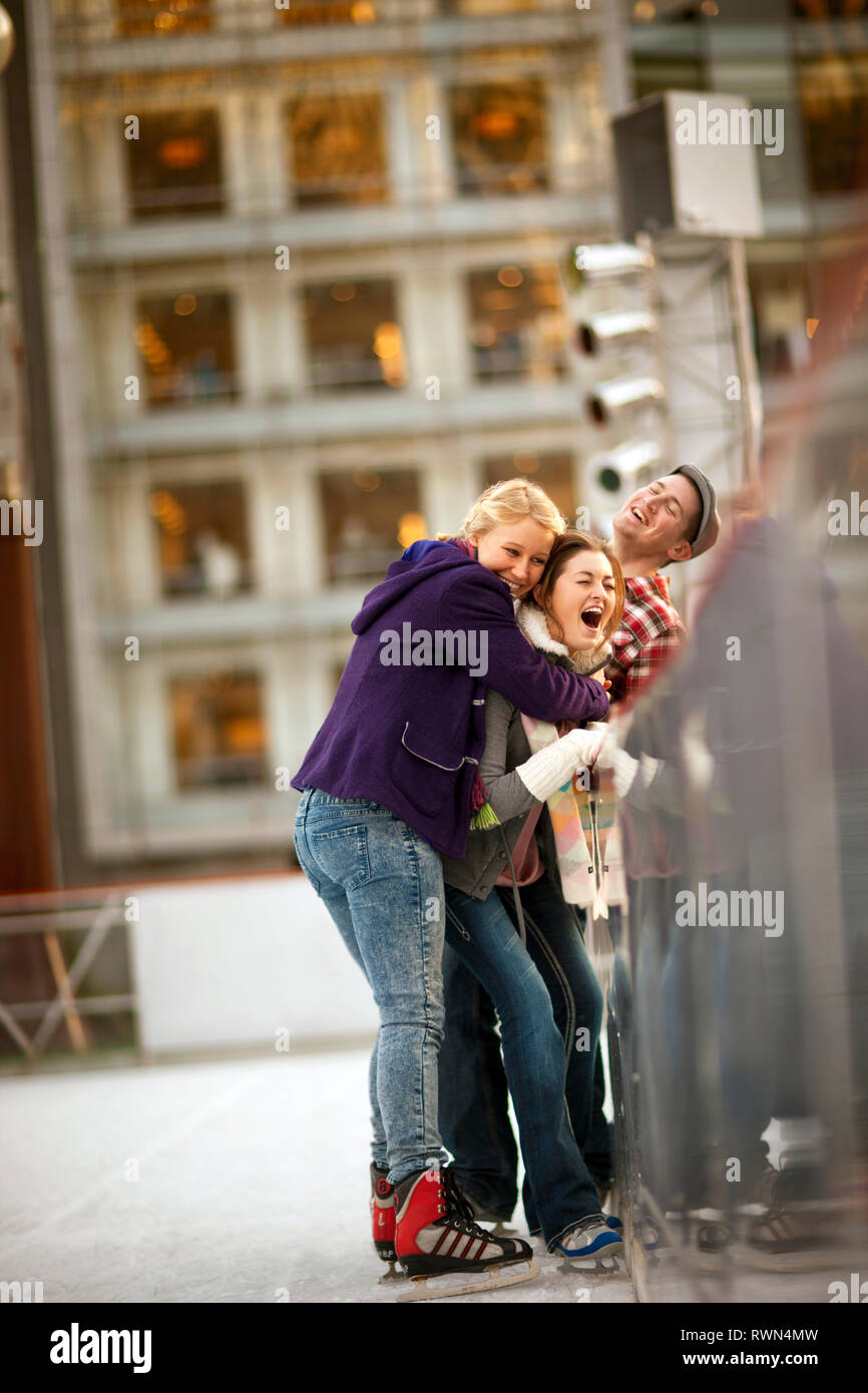 Three friends having fun ice-skating together Stock Photo - Alamy
