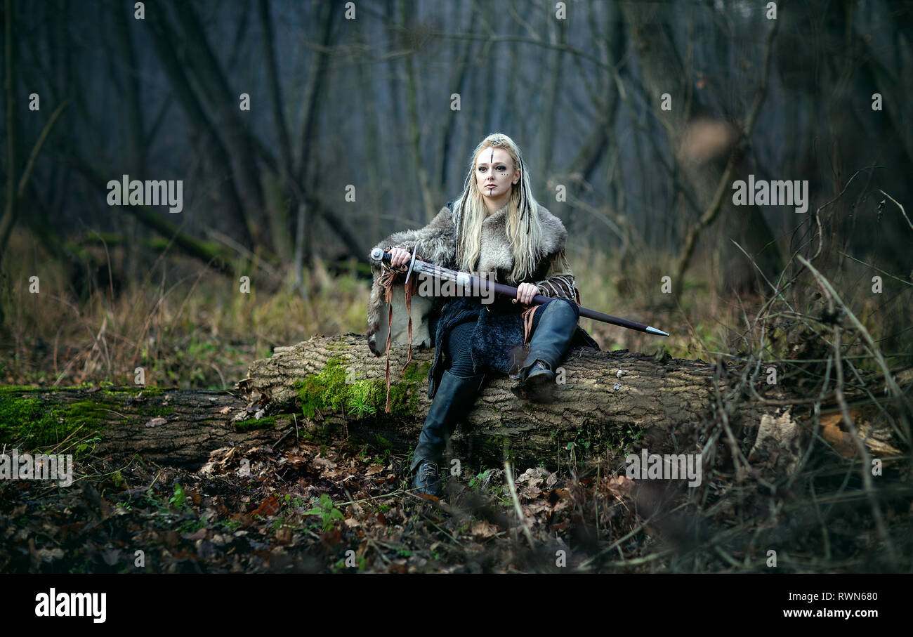 Mad furious viking woman warrior with a sword in her hands, in the ...