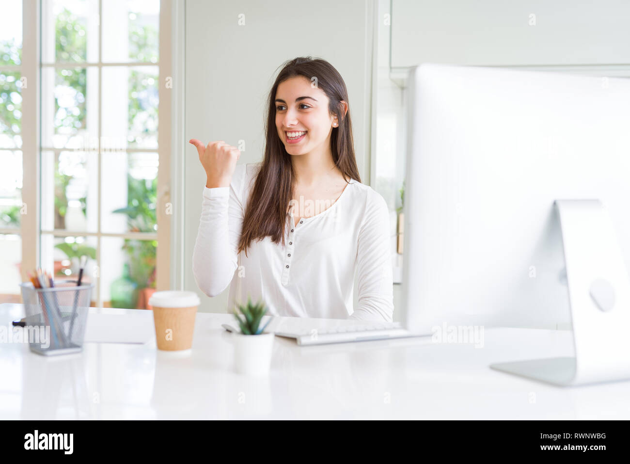 Beautiful young woman working using computer smiling with happy face ...