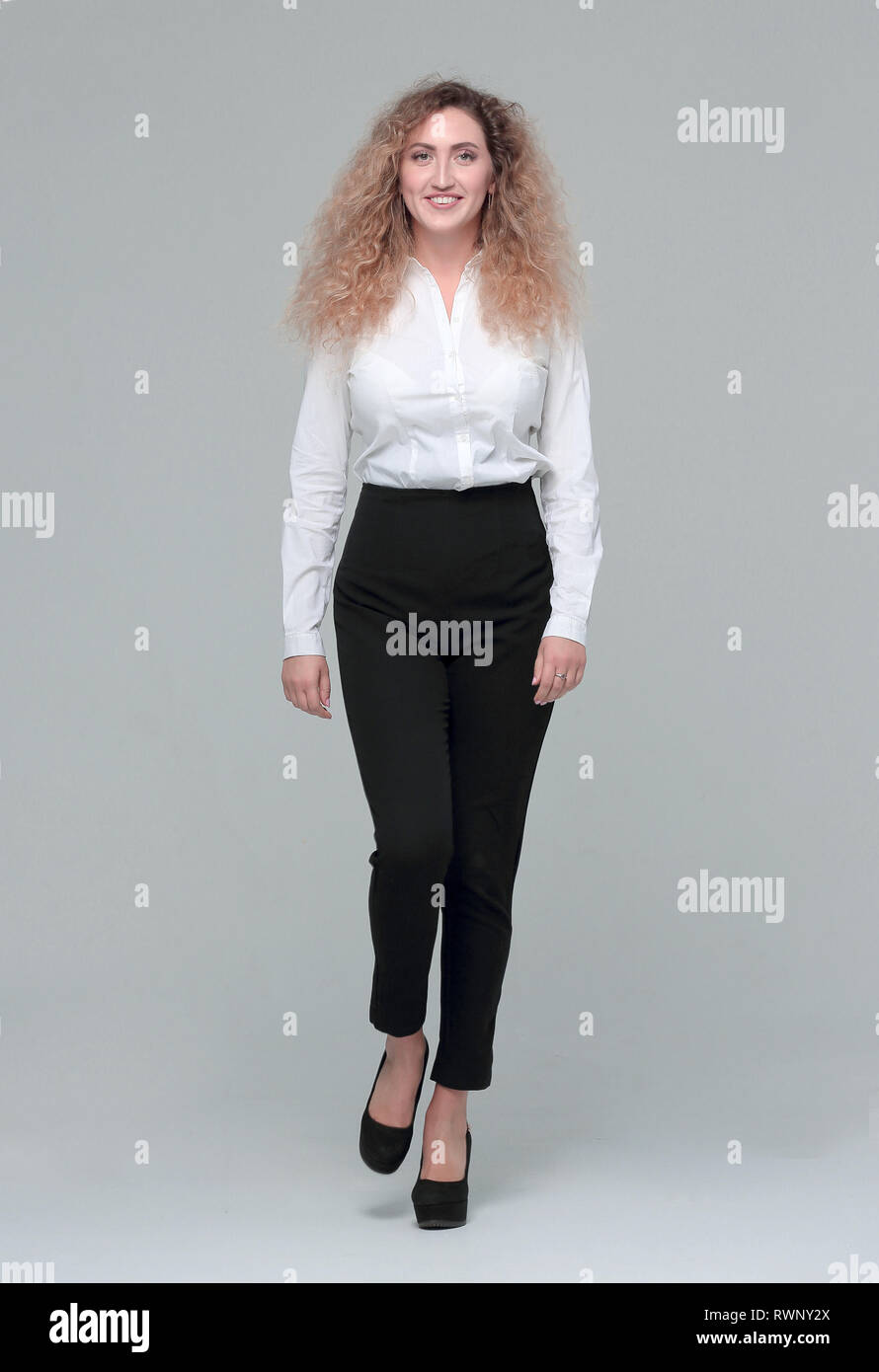 business woman striding confidently forward Stock Photo - Alamy