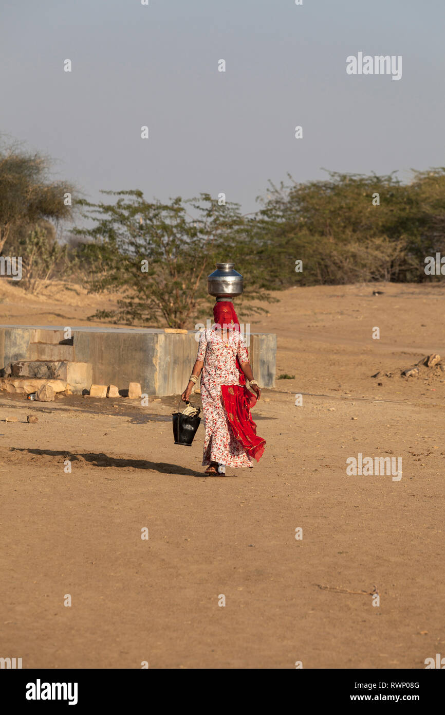 Woman fetching water in the the Thar Desert, Khuri , Rajasthan, India ...