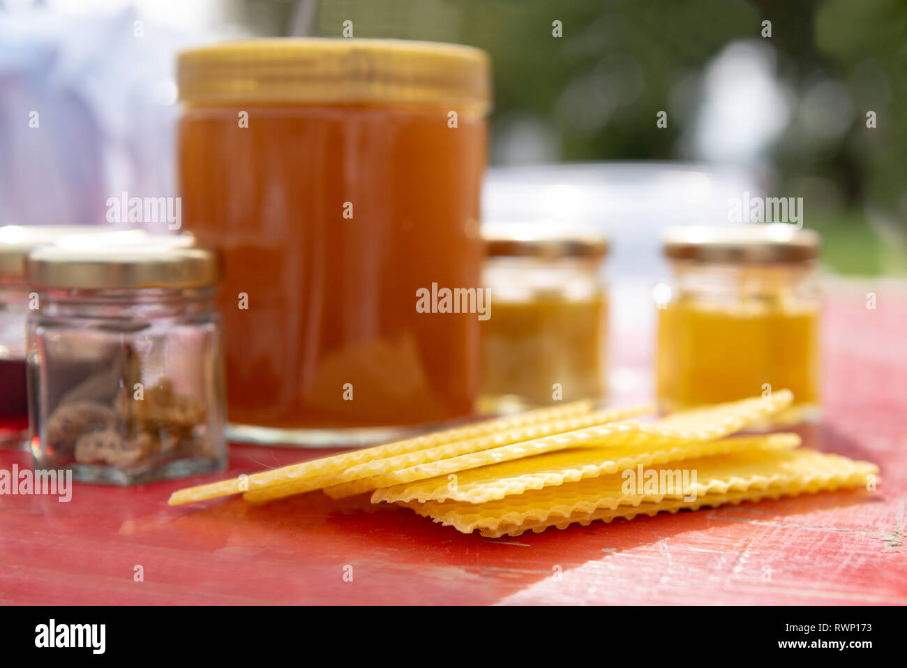 various products such as propolis, honey wax plates against blurred ...