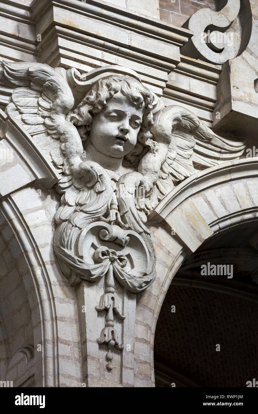 Decorative angel sculpture on a building with arches; Brussels, Belgium ...