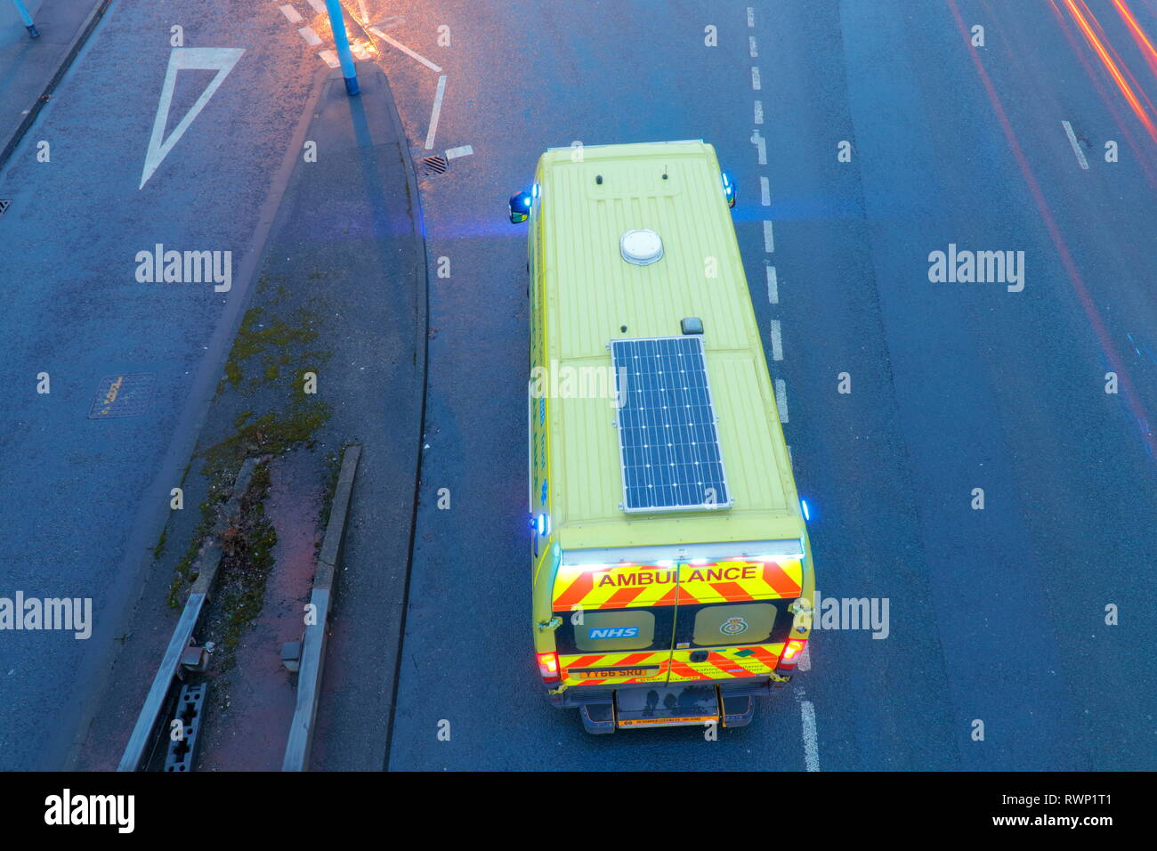 An ambulance parked in front of a car that collided with a crash ...