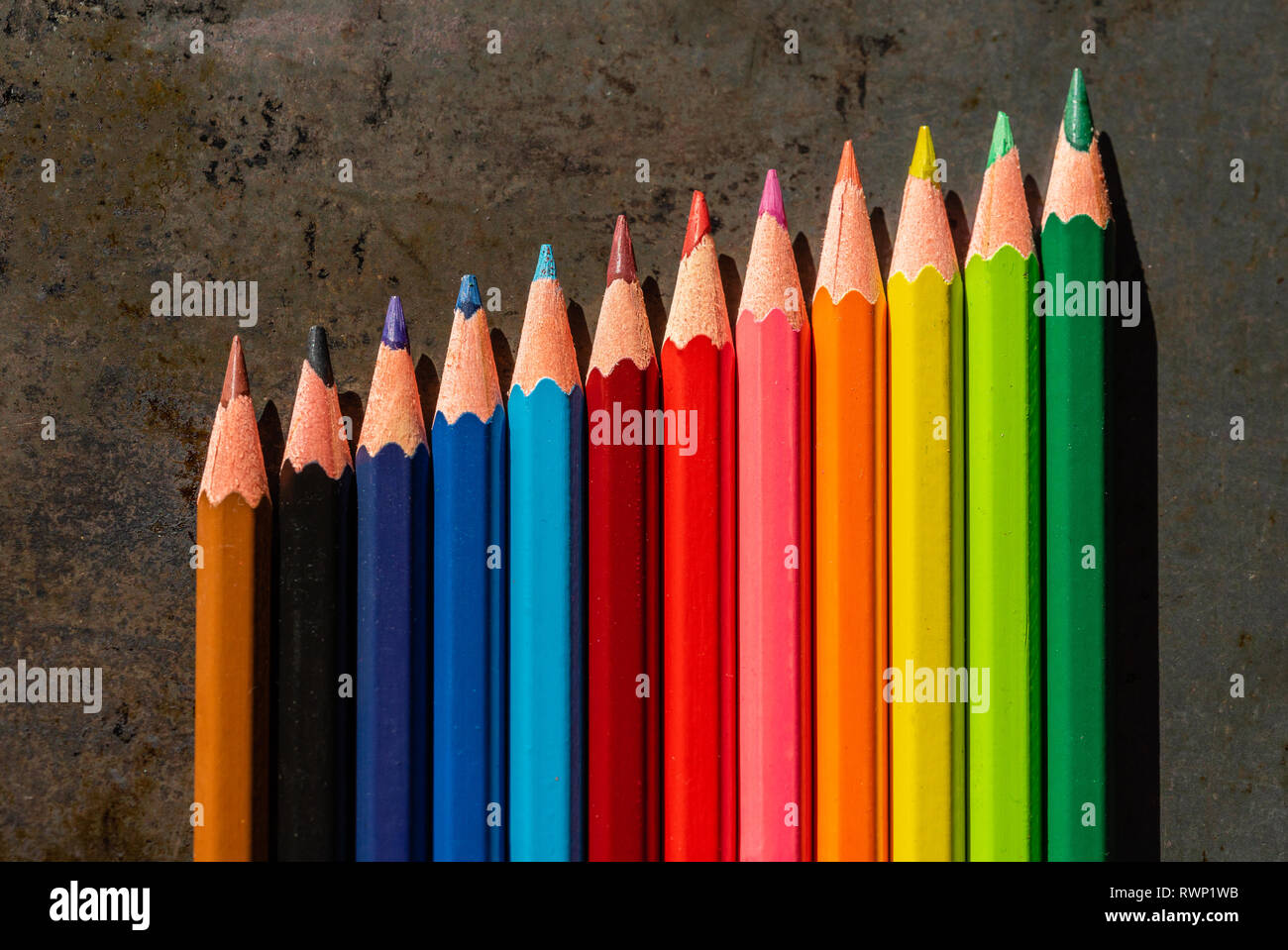 Coloured pencils lined up in a row - colourful concept Stock Photo - Alamy