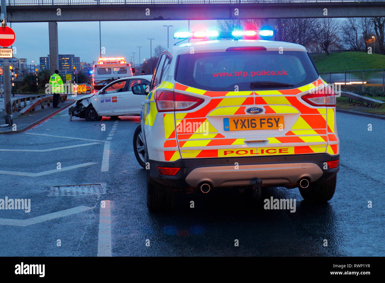A police vehicle blocks 1 lane of a dual carriageway , while a recovery ...