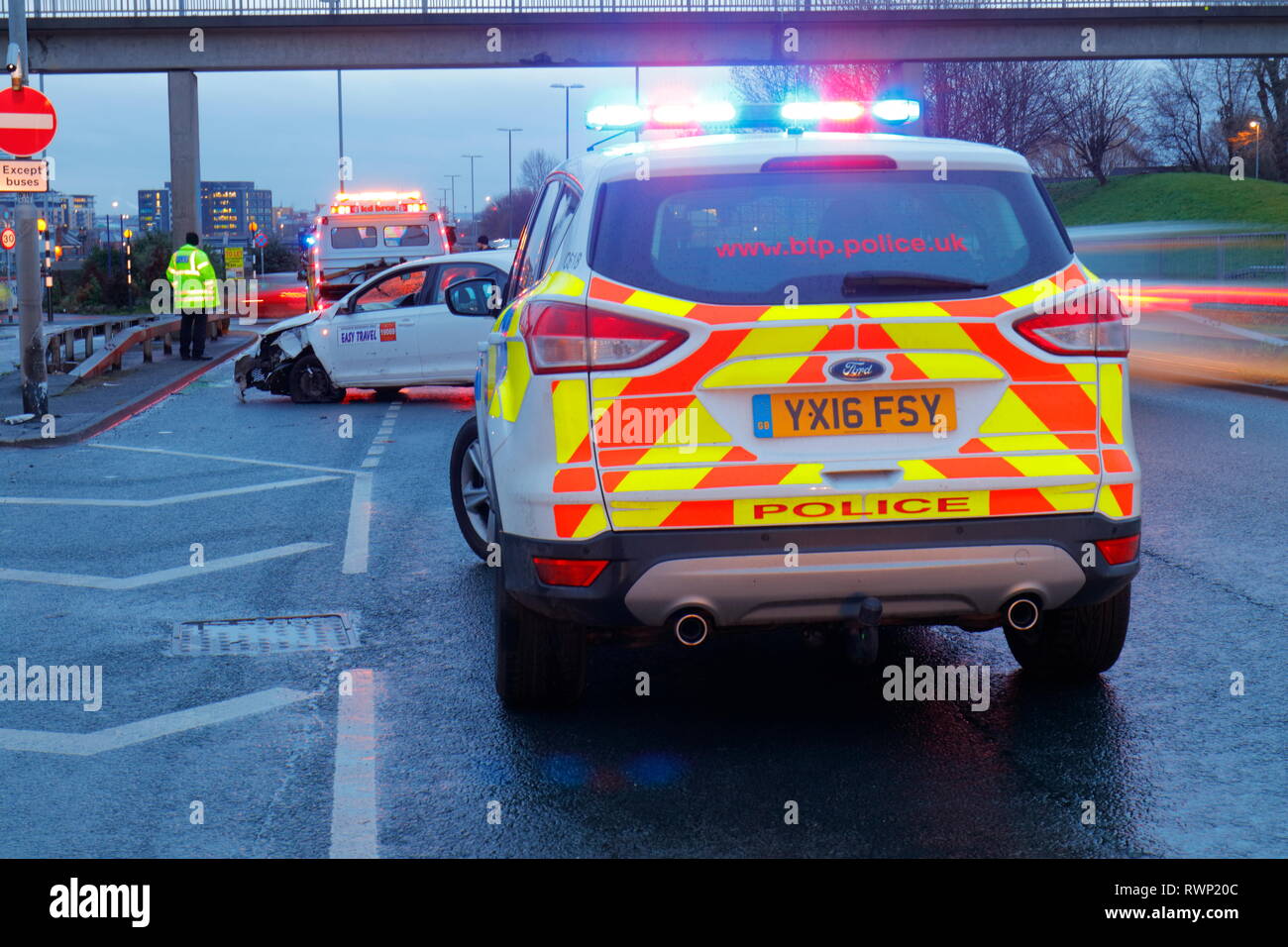A police vehicle blocks 1 lane of a dual carriageway , while a recovery ...
