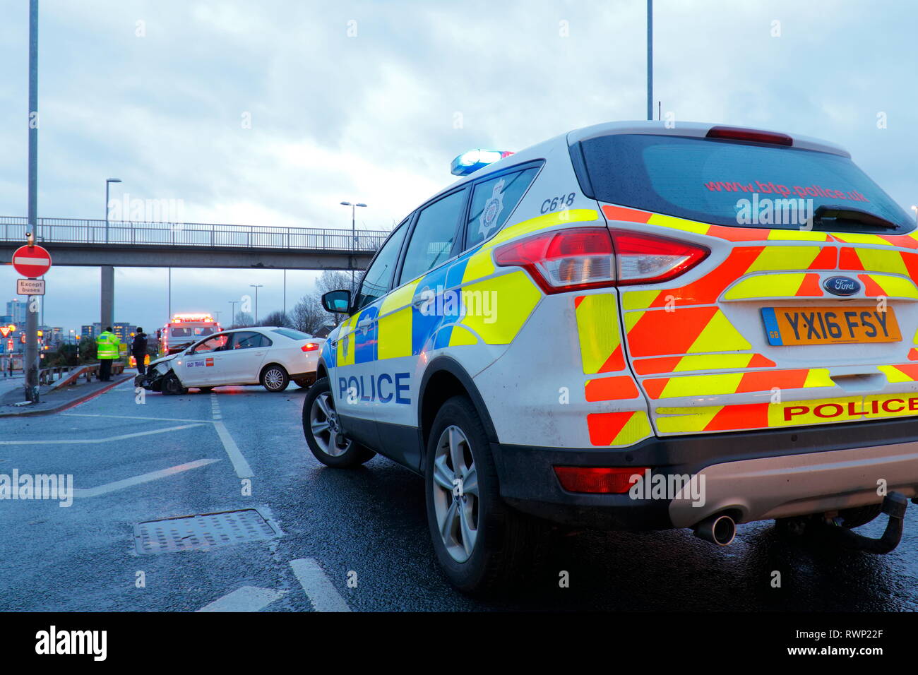 A police vehicle blocks 1 lane of a dual carriageway , while a recovery ...