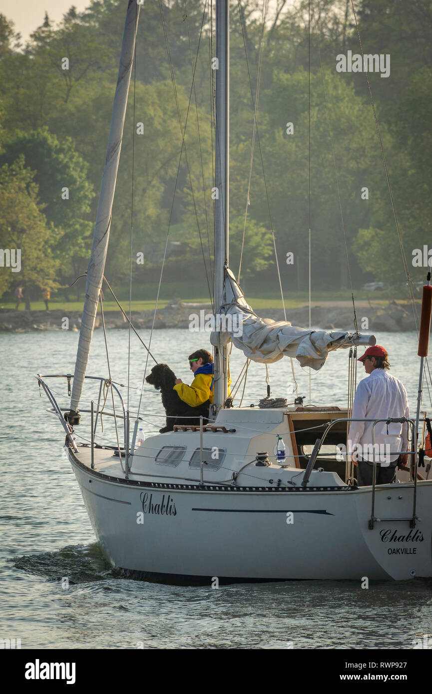 Yacht with sails down entering Oakville marina on lake Ontario Stock ...