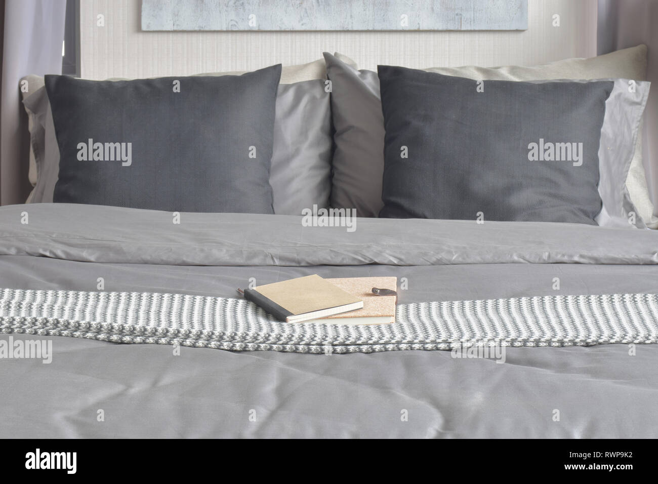 Notebooks on blanket in gray color scheme bedding Stock Photo - Alamy
