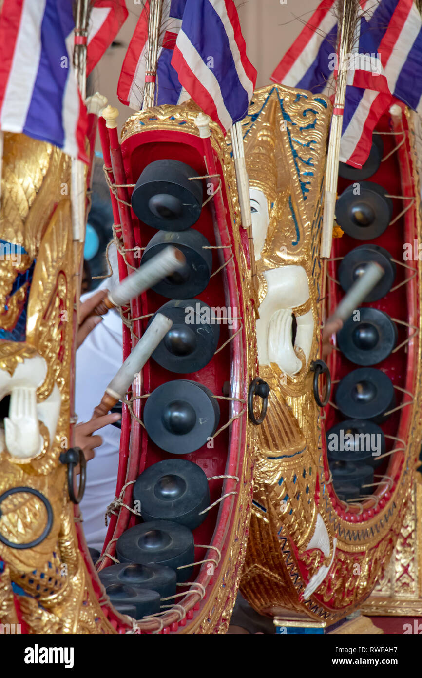 Playing a traditional musical instrument Khong Wong on the background ...