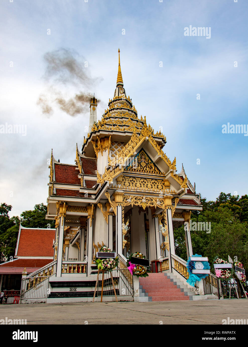 Crematorium in Buddhist monastery with smoke rising from chimney after ...
