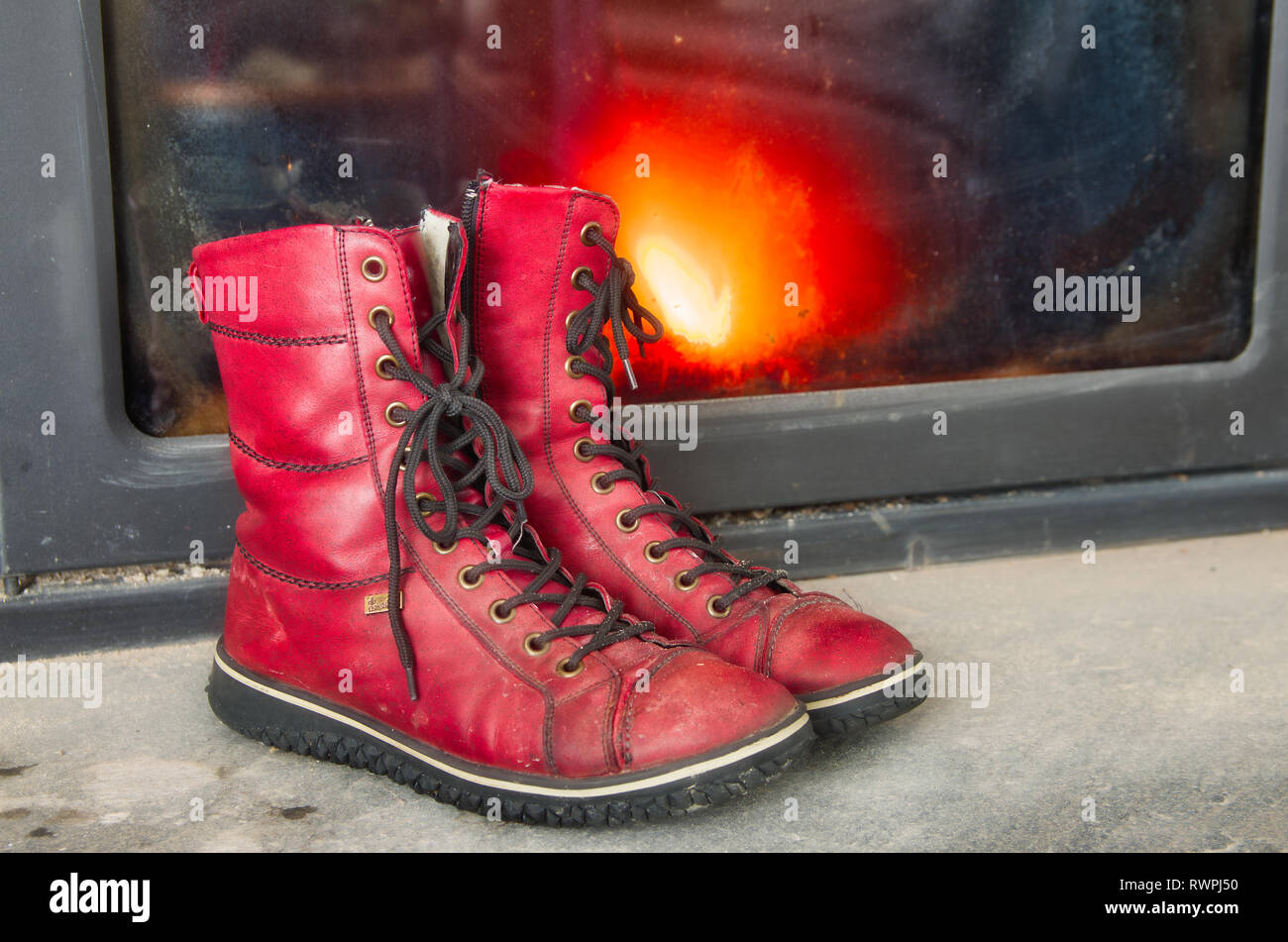 Red boots by the fire Stock Photo - Alamy