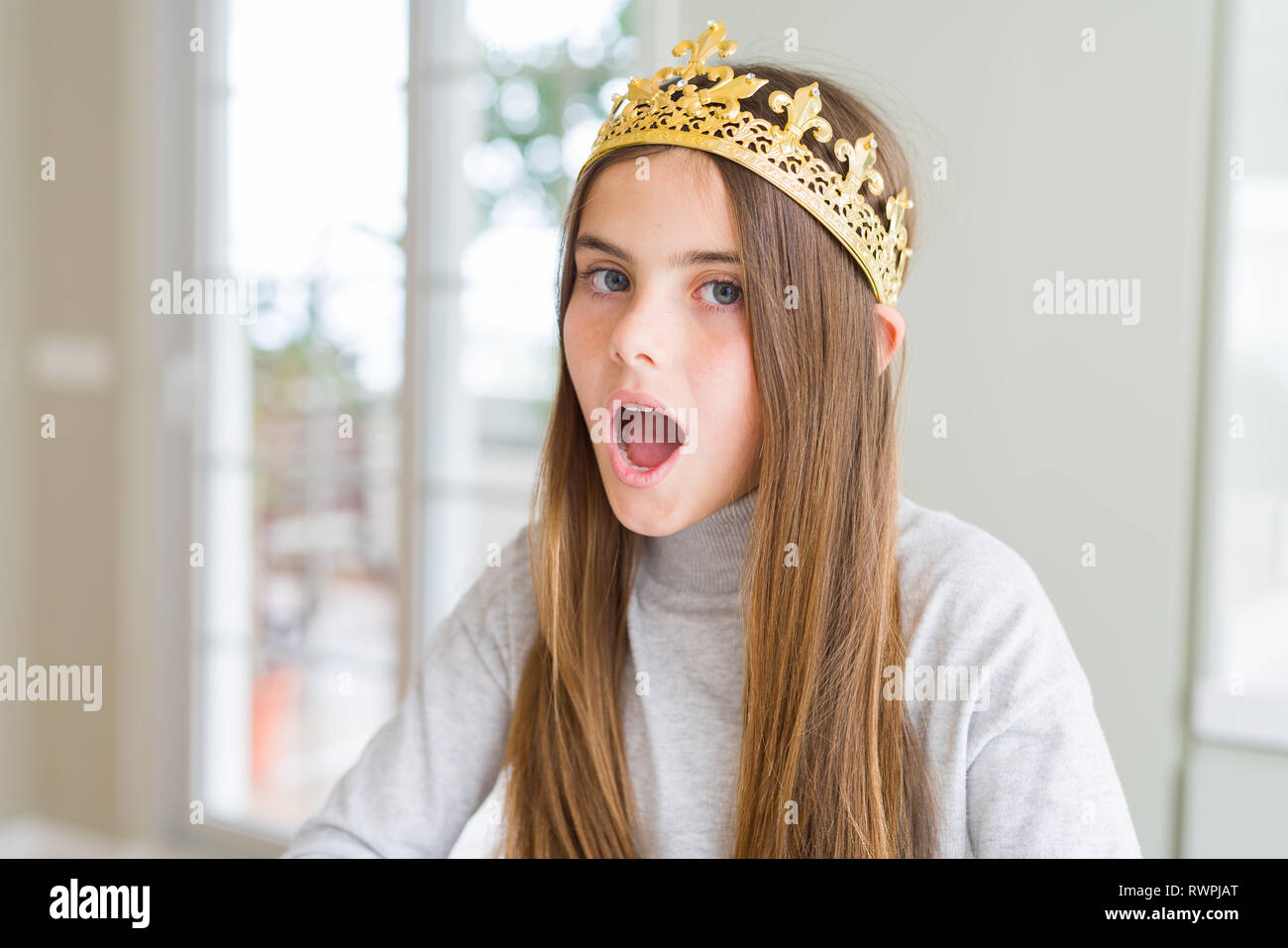 Beautiful young girl wearing a golden crown as a princess from ...