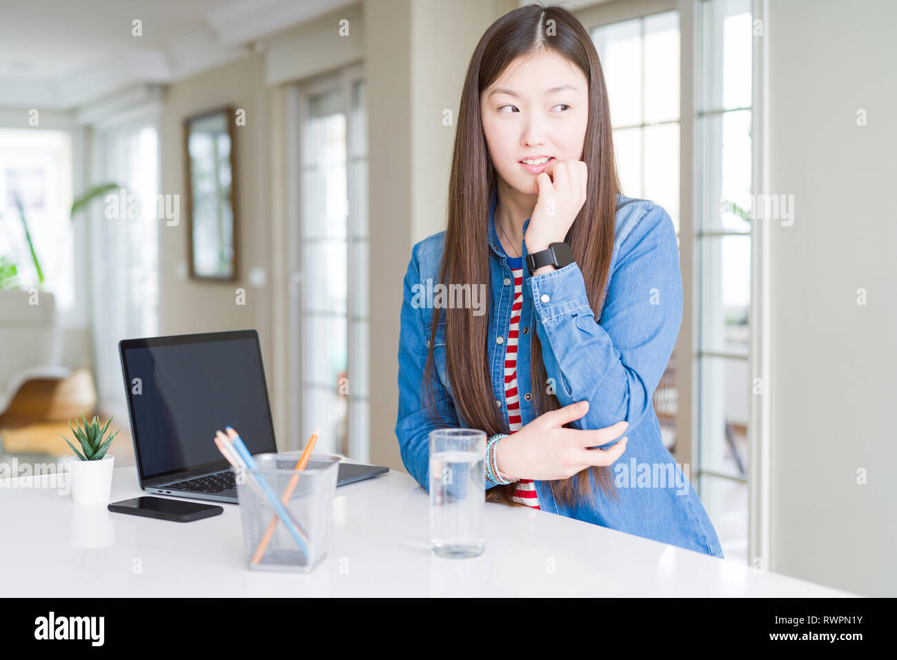 Beautiful Asian woman working using computer laptop looking stressed ...