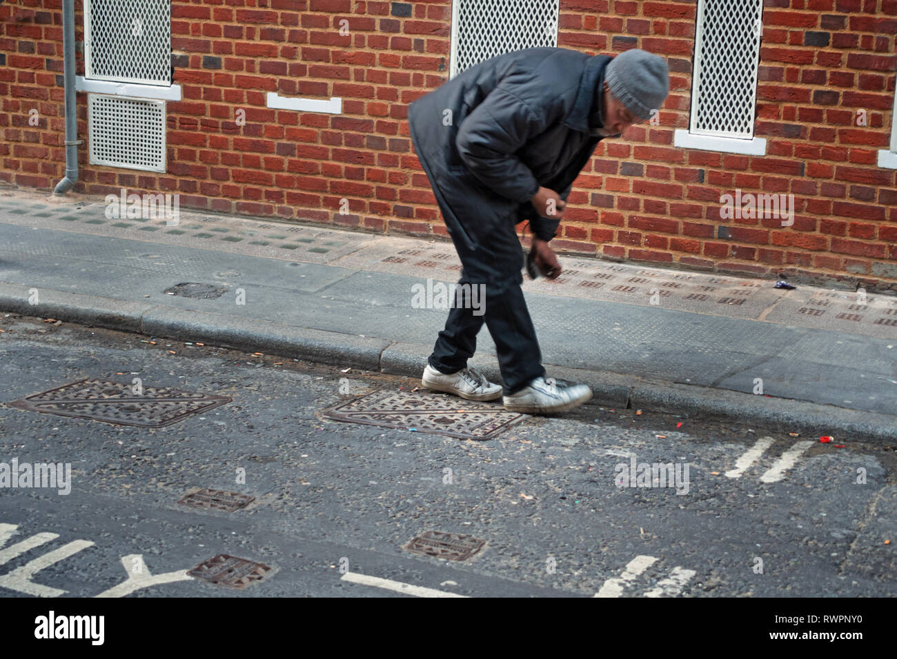 Man stooping hi-res stock photography and images - Alamy