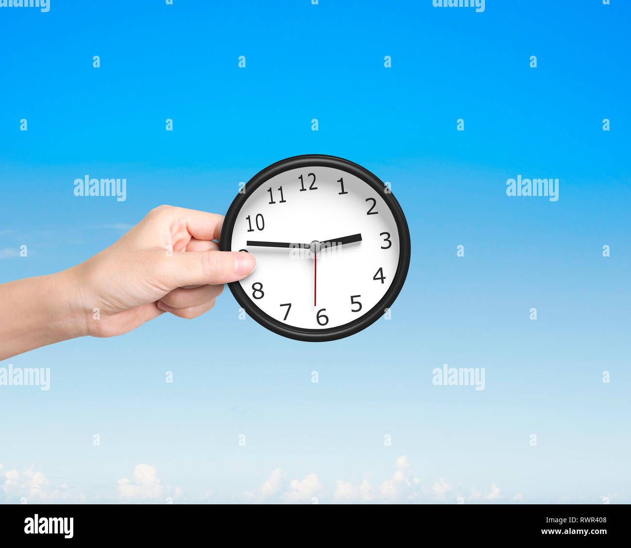 Hand putting a black-white clock. Time is money concept Stock Photo - Alamy