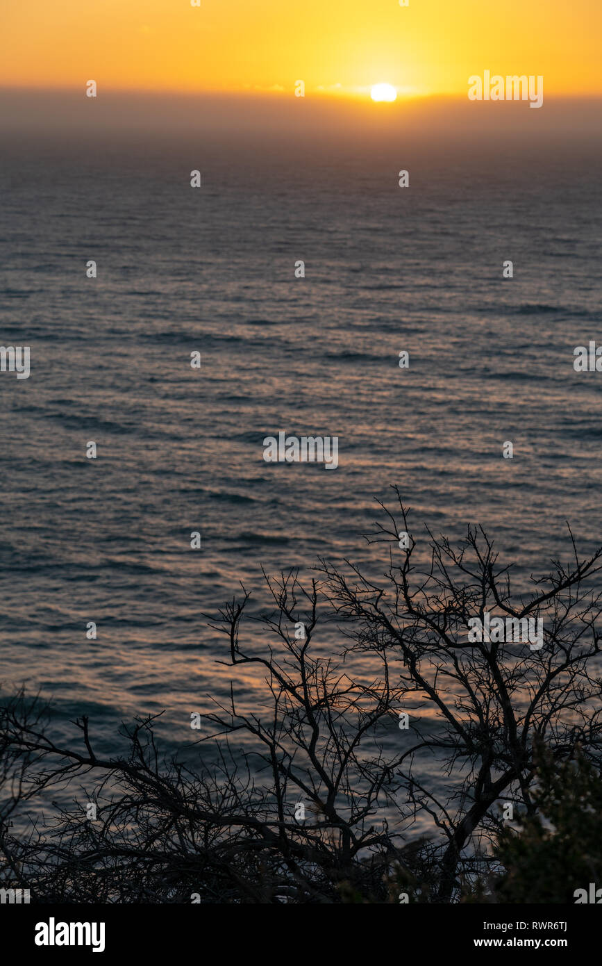 Big Sur, California - View of the sun setting on the horizon from a ...