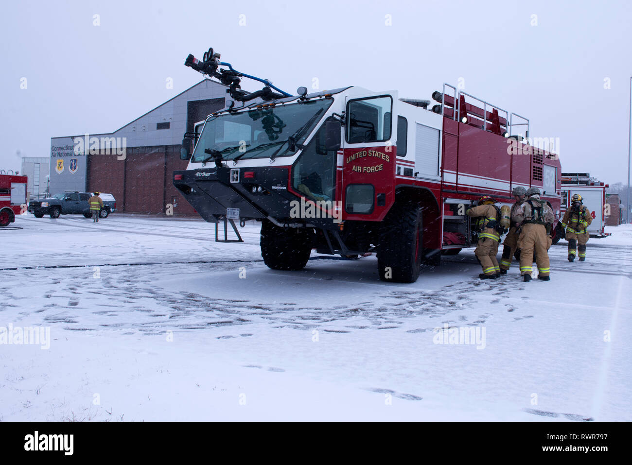 Firefighters assigned to the 103rd Civil Engineer Squadron prepare to ...