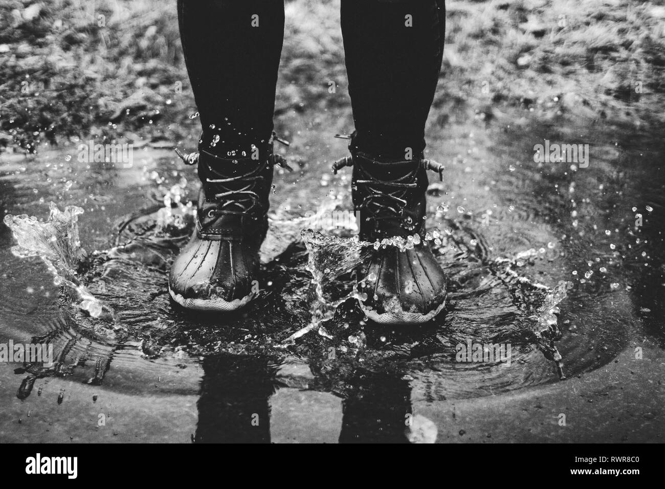 A person in a puddle of water Stock Photo - Alamy
