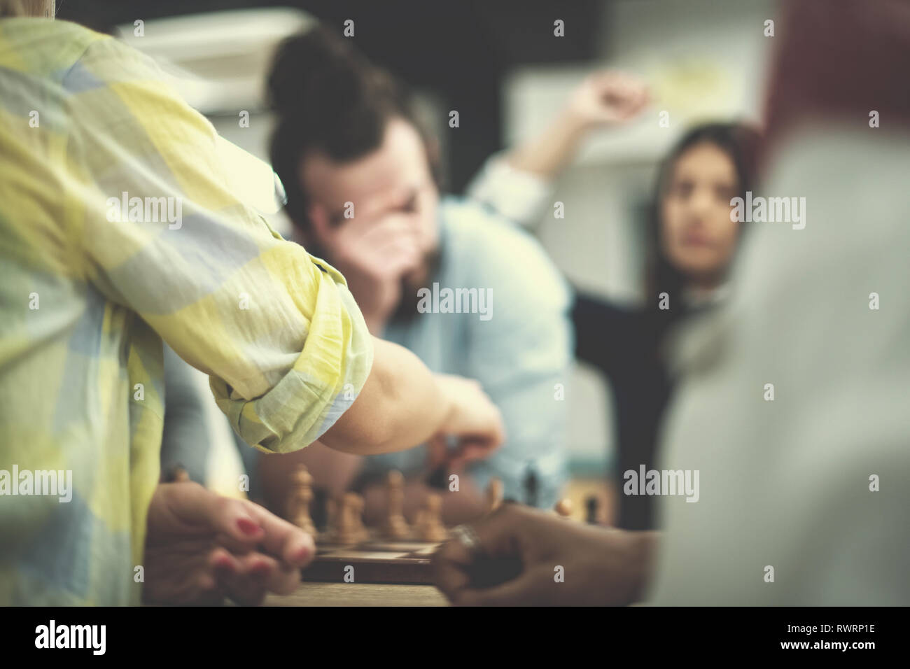 a multiethnic group of business people playing chess while having a ...