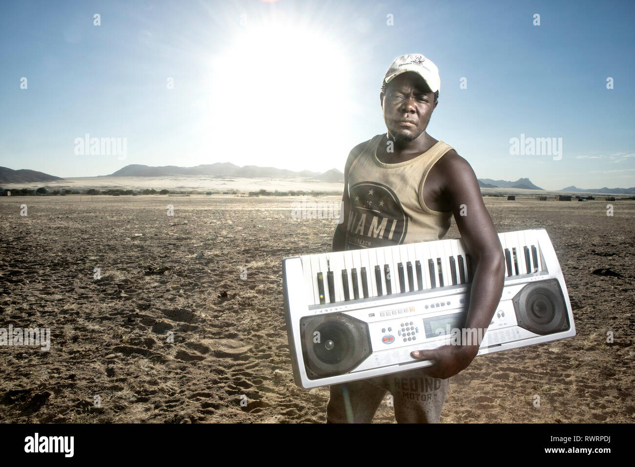 A man walks through the arid desert of Purros, Kunene Region, Namibia ...