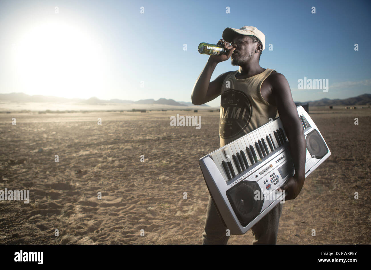 A man walks through the arid desert of Purros, Kunene Region, Namibia ...