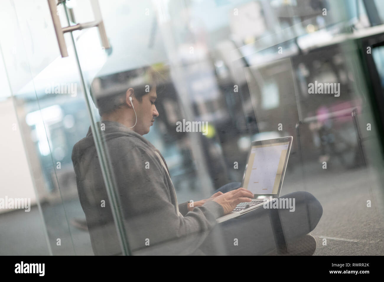 Young Indian Software Developer Man Using Laptop Computer Writing Programming Code While Sitting