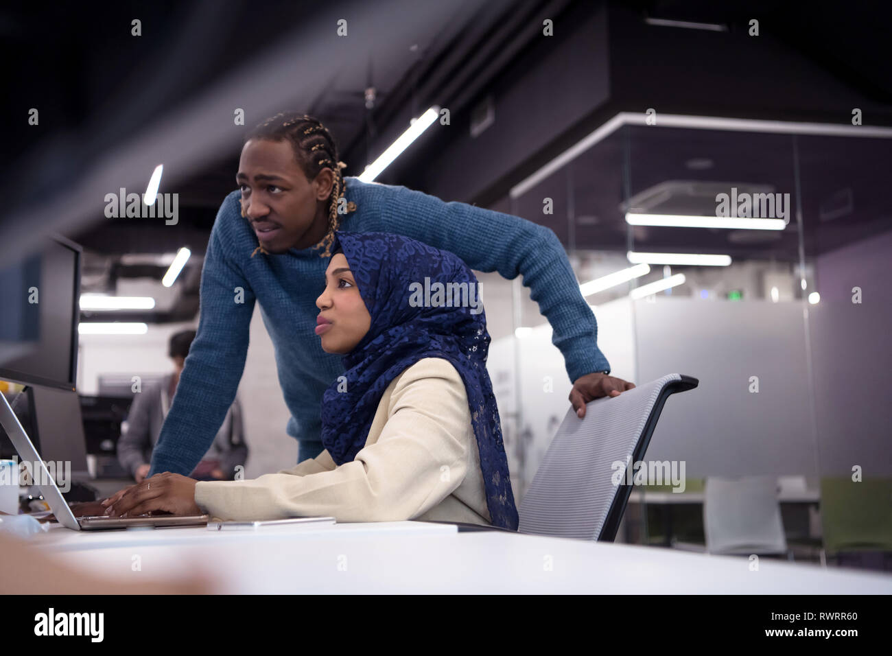 black muslim female software developer working together with her ...