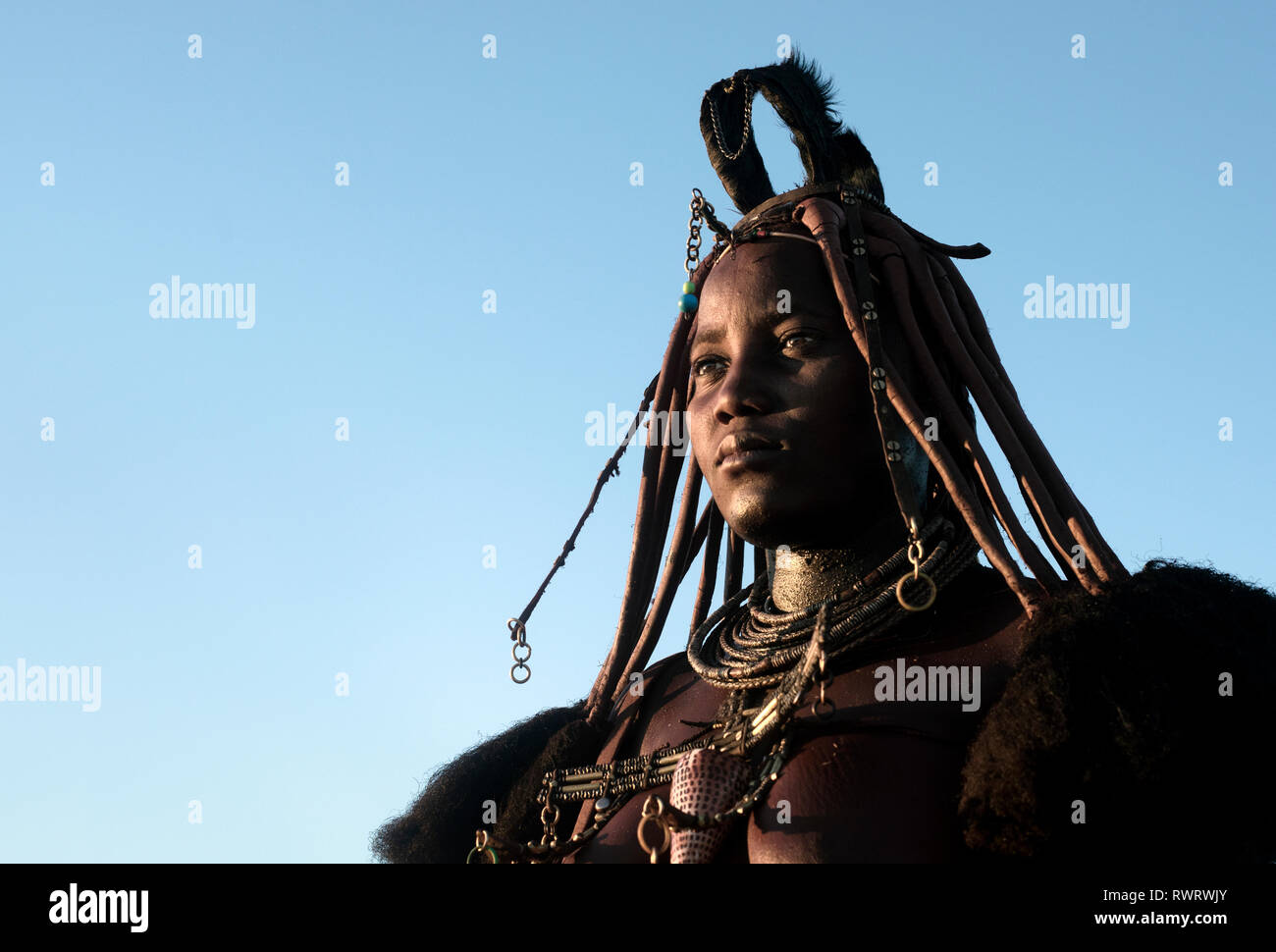 A side lit portrait of a Himba woman in the Kunene Region of Namibia ...