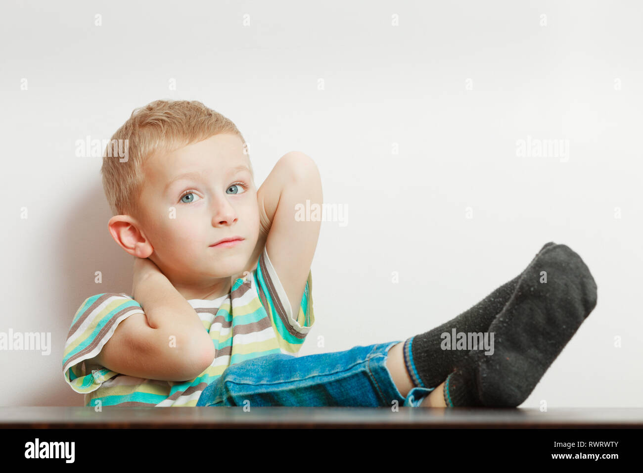Face expressions, children concept. Portrait of happy kid boy sitting ...