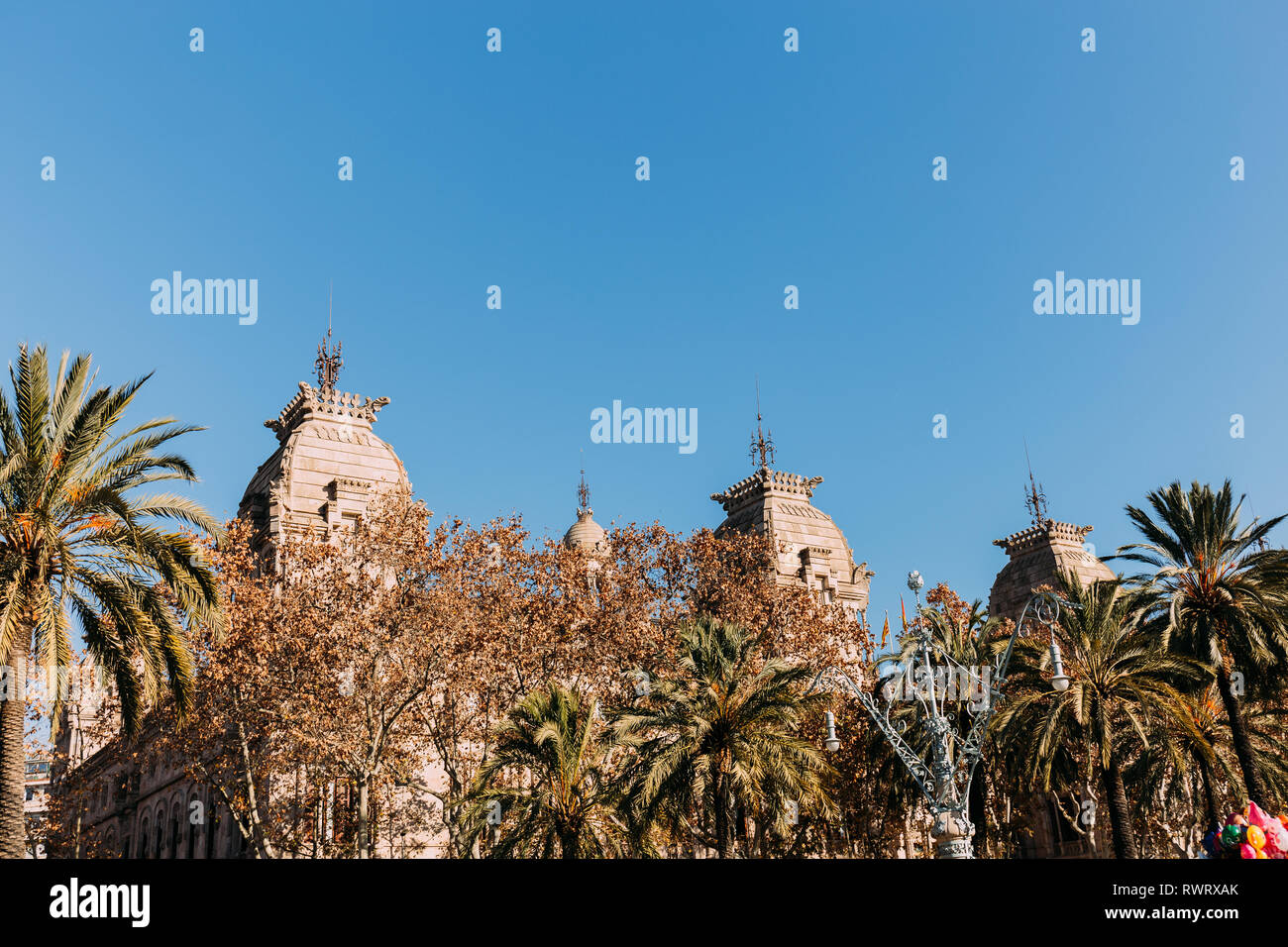 old building with towers behind green trees, barcelona, spain Stock ...