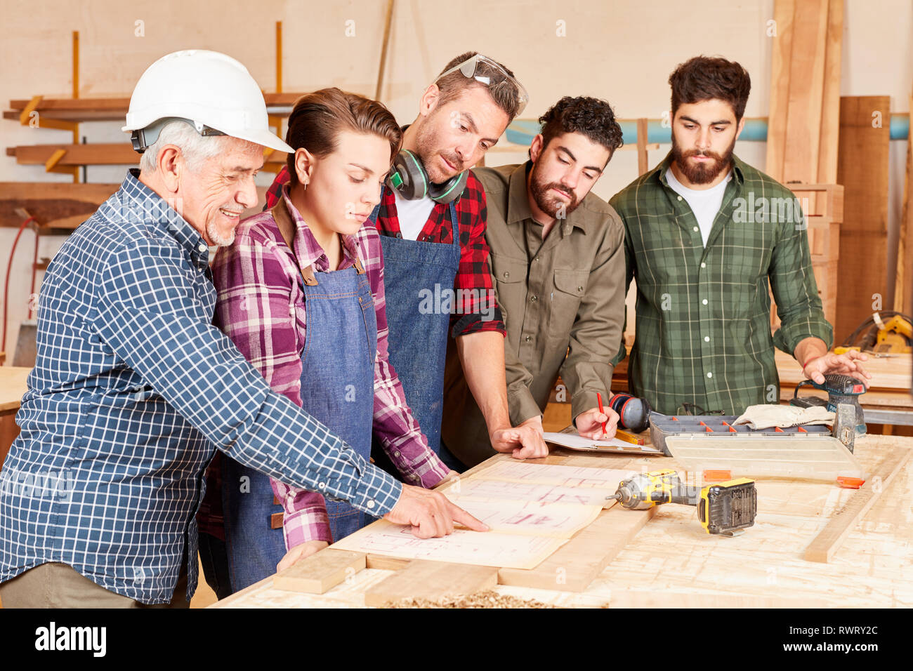 Competent craftsman team with drawing in a construction planning ...
