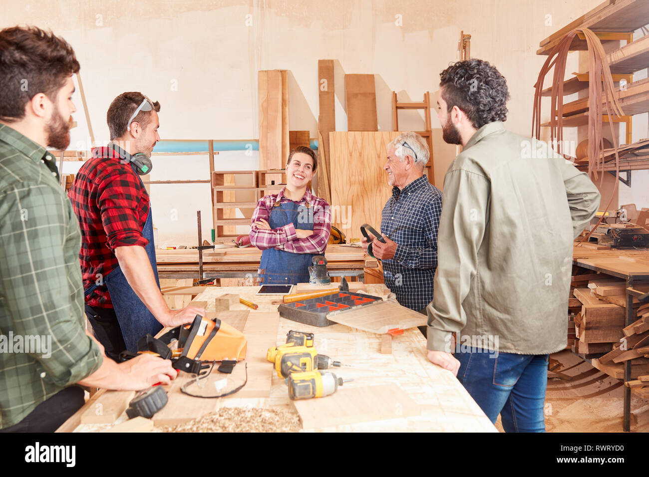 Group of carpenters or carpenters with trainees at a meeting in the ...