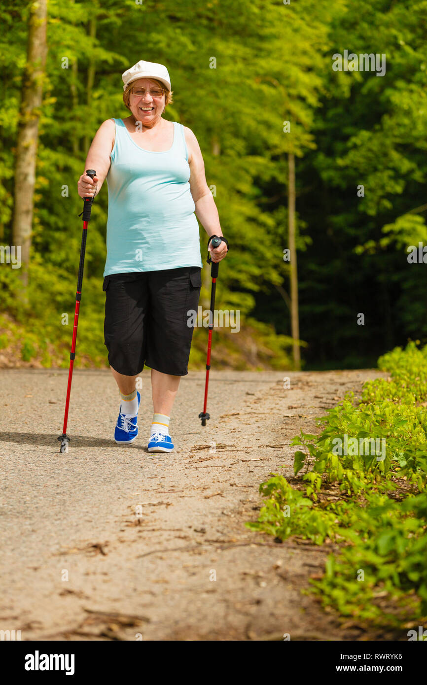 Healthy active retirement concept. Senior woman practicing nordic ...